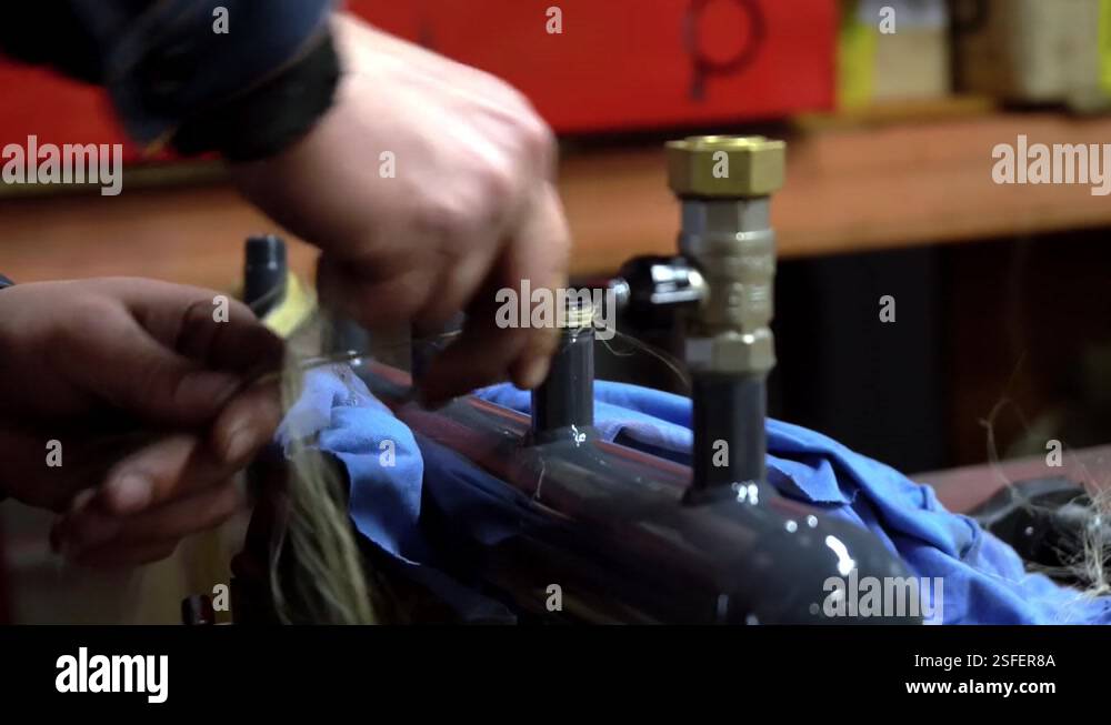 Worker Coils Rope to the Tip of Steel Plumbing Pipe During Production ...
