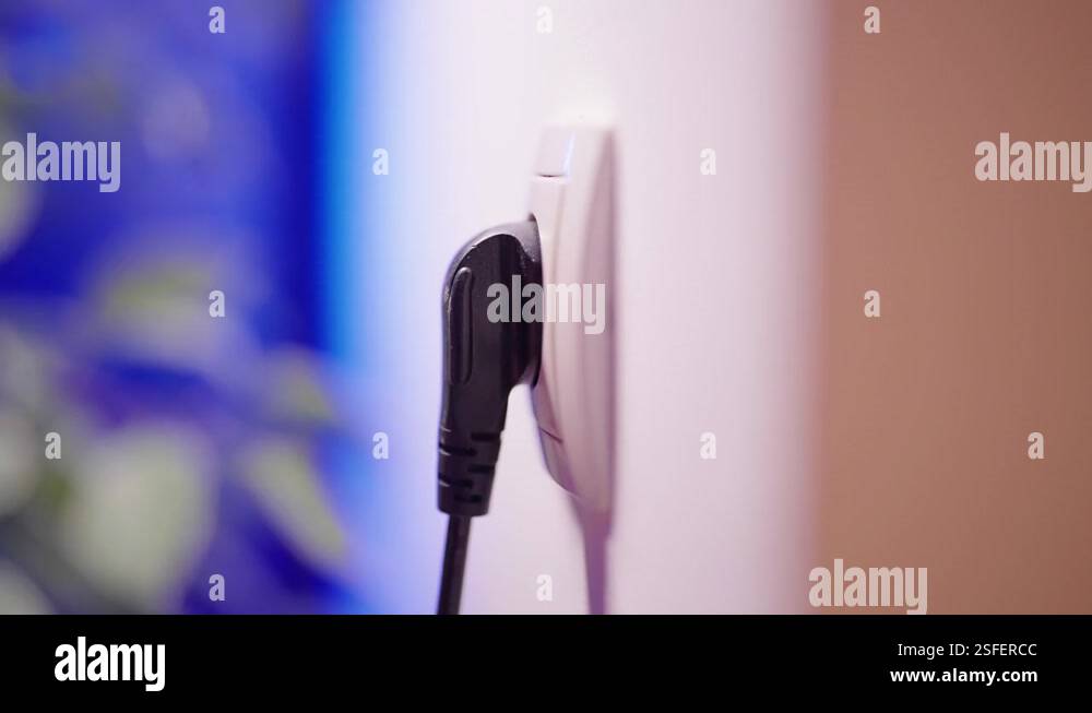 Plug in and plug out thick black cable turned downwards close-up 4K ...