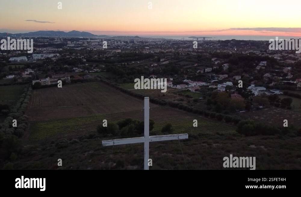 Drone Shot (moving backwards) revealing a Big Cross in front of Sunset ...