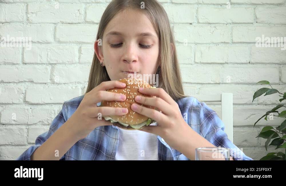 Girl Eating Fast Food, Adolescent Child Eats Hamburger in Restaurant ...