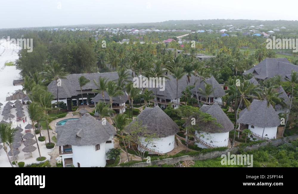 Bungalow hotel houses with palms on white sand beach of Zanzibar Stock ...