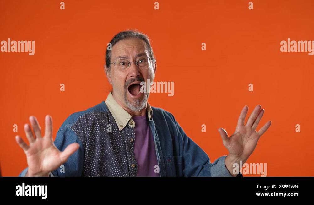 Scared shocked elderly bearded man 50s 60s look camera covering hiding ...