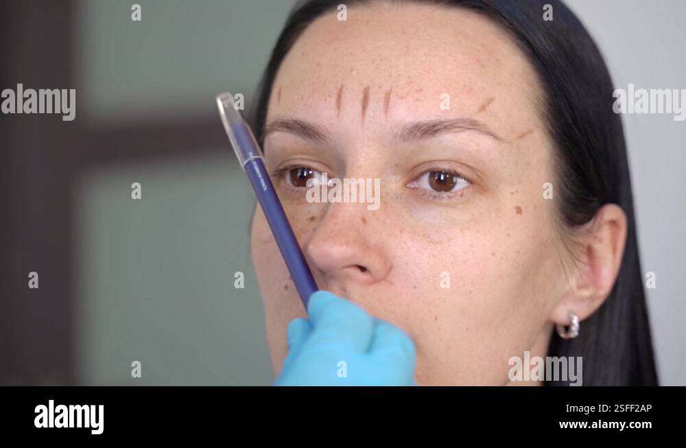 close-up of a female face on which markings are applied to build the ...
