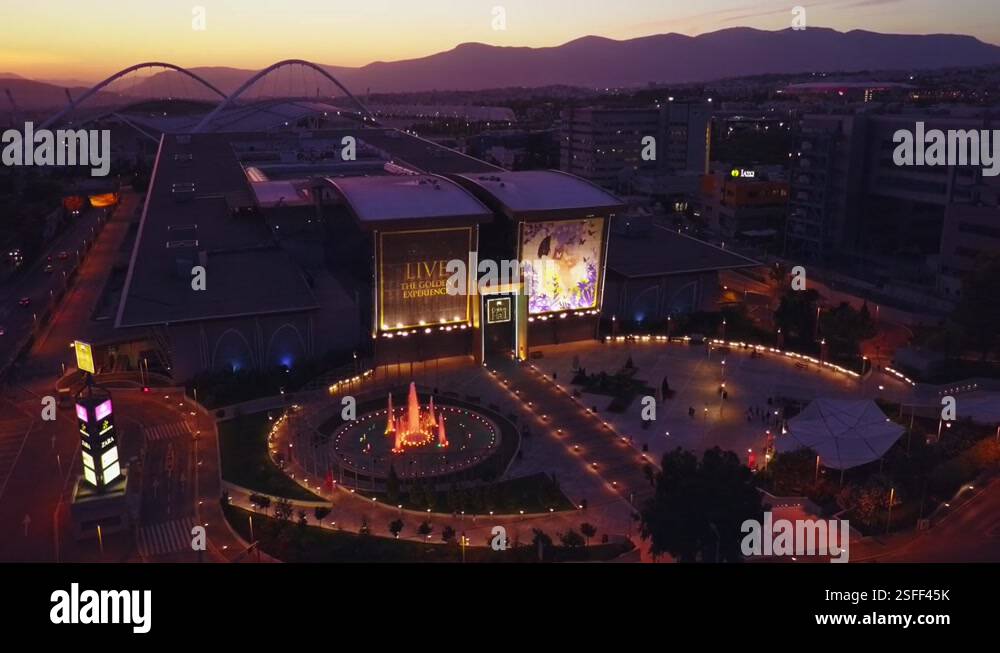 Aerial footage of Golden Hall mega mall in Athens, Greece at sunset ...