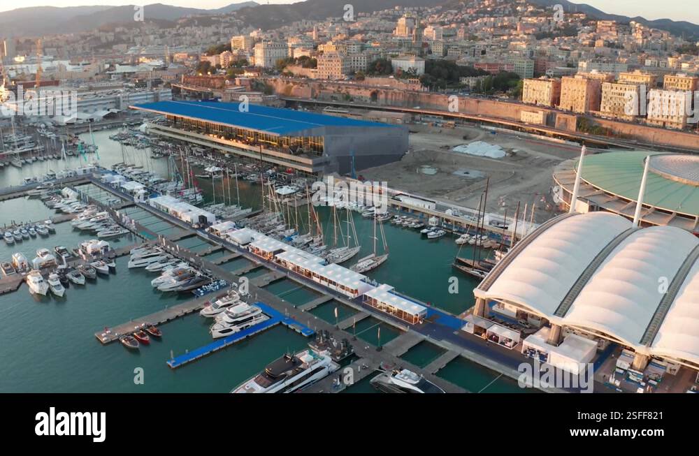 drone flying above the port of genova during sunset. flying backwards ...