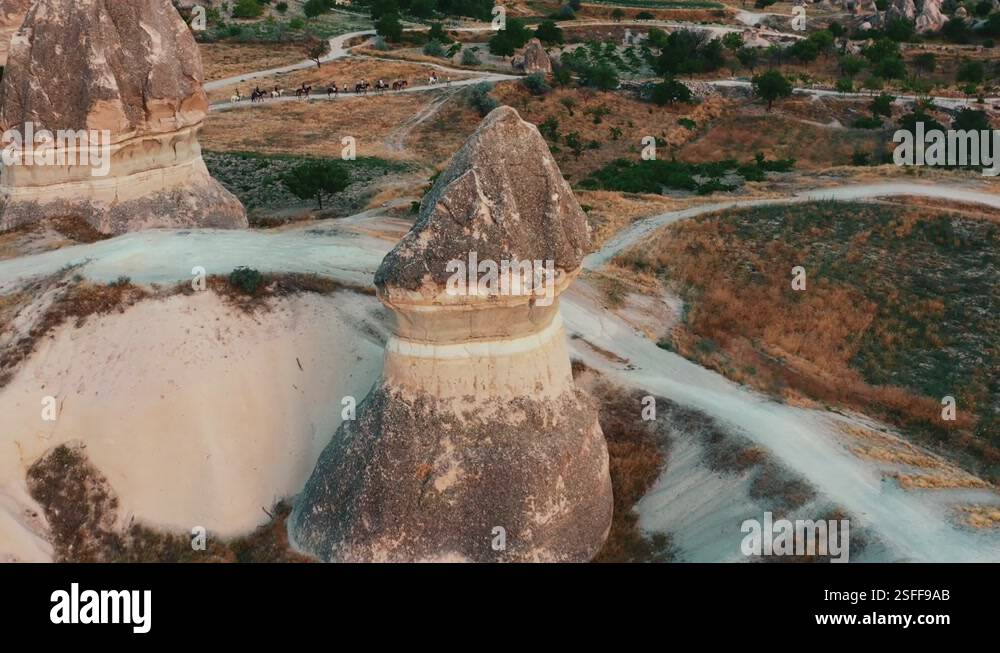 Drone flying around beautiful tall white rock with signs of beautiful ...