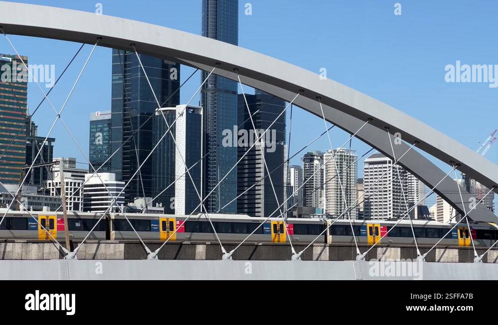Railway train crossing river through merivale arch bridge at brisbane ...