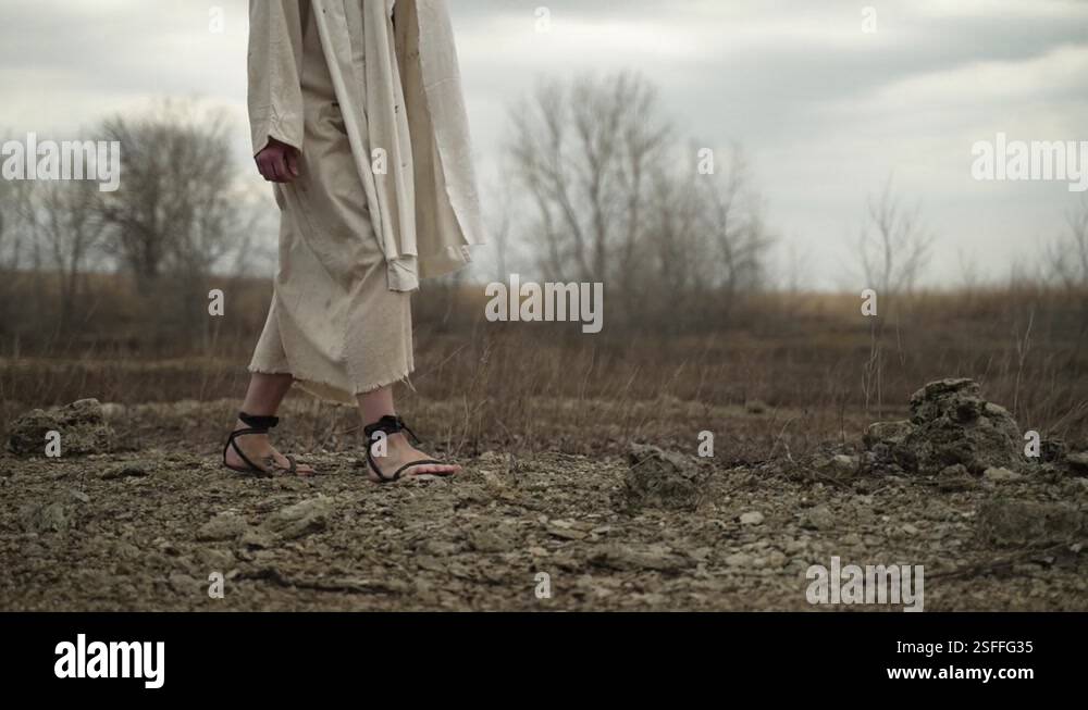 The feet of Jesus Christ or a biblical prophet wearing a white tunic ...