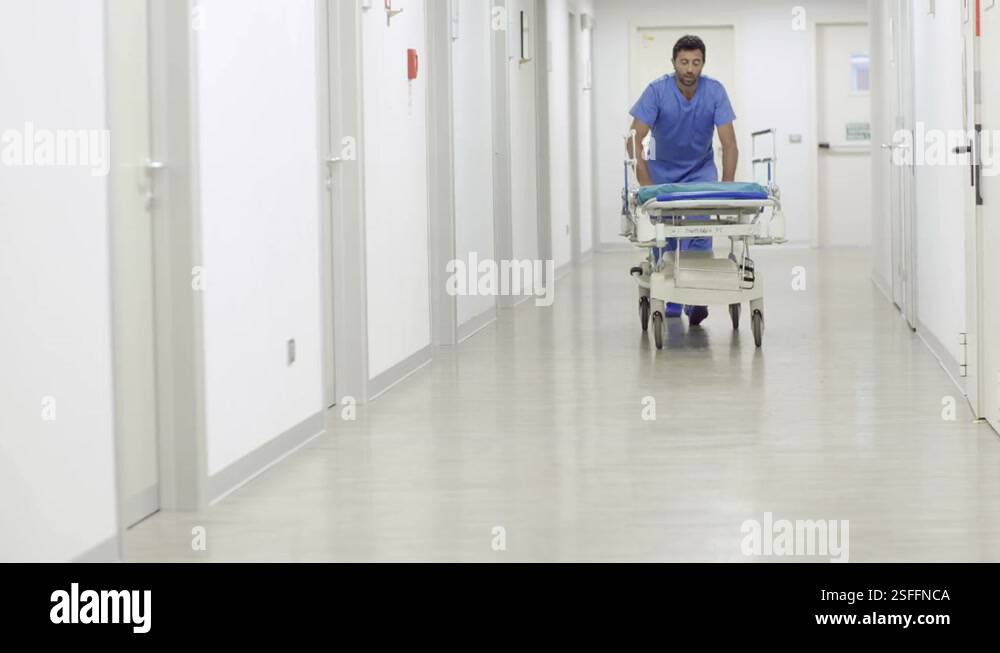 Male nurse pushing empty gurney Stock Video Footage - Alamy