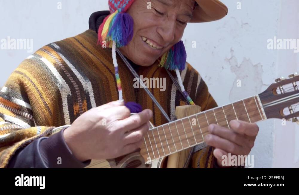 Native street performer, busker, plays charango and pan flute, Cuzco ...