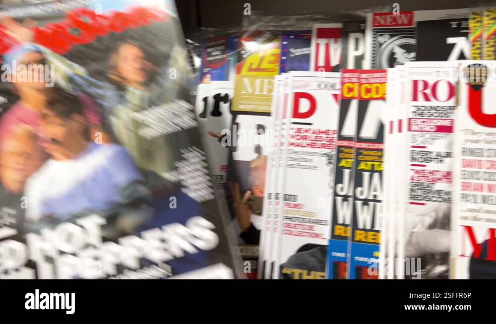 Man reading at press kiosk at Elements newspaper magazine featuring ...