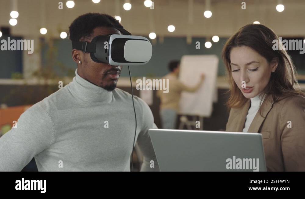 African american businessman testing a VR simulator headset and ...