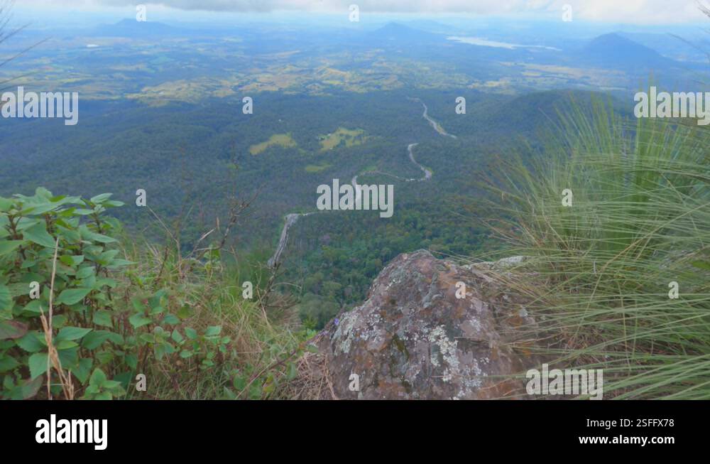 4K UHD view of a winding road up mountain range, clouds pass by with ...