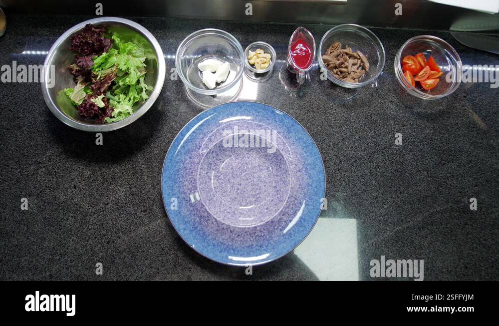 The ingredients for the salad are laid out on the table using a blue ...