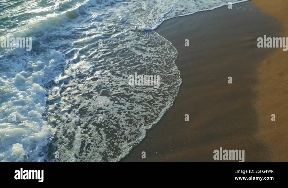 Beach, foamy ocean, sea waves washing sand. Waves hitting sand beach in ...