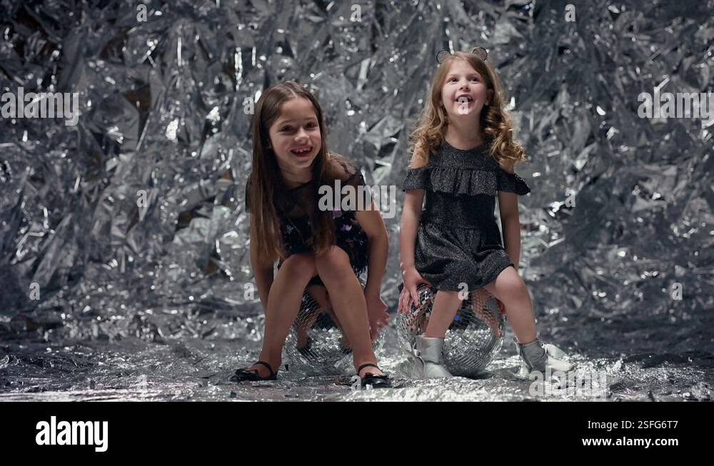 Two Girls On Shiny Background. Girls In Festive Dresses. Girls Sitting ...