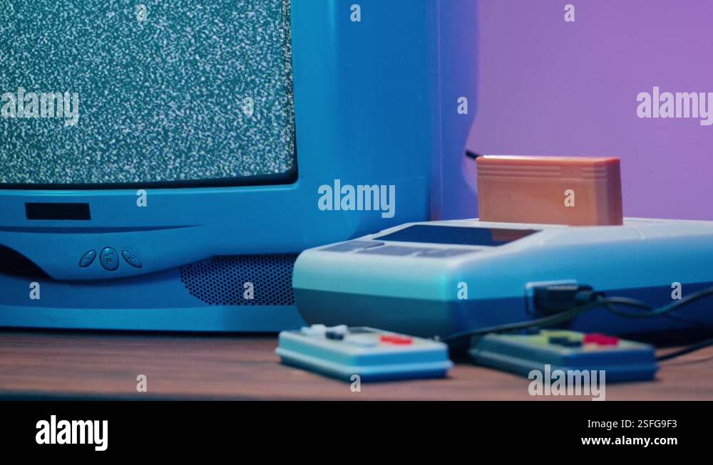 Old television with grey interference screen on purple neon background ...