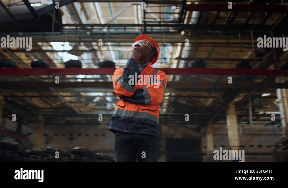 Industrial supervisor thinking wearing safety uniform at modern ...