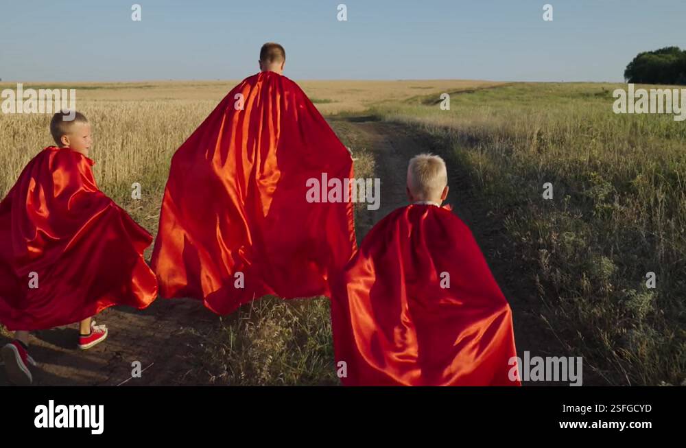 Friends dream of becoming superhero. Boys in red coats. Happy children ...