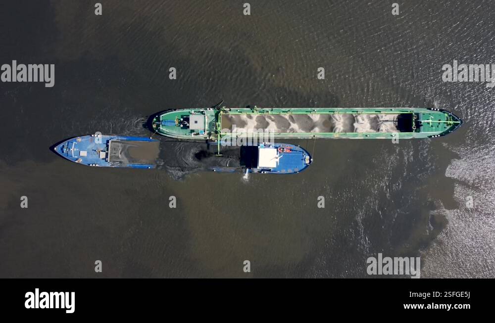 Dredging ship dredges off mud from river bottom to improve the fairway ...