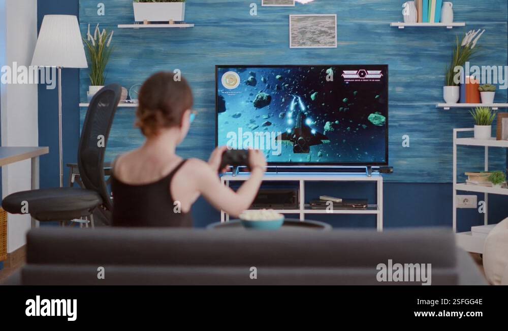 Gamer girl holding controller celebrating victory in online first person shooter Stock Video ...