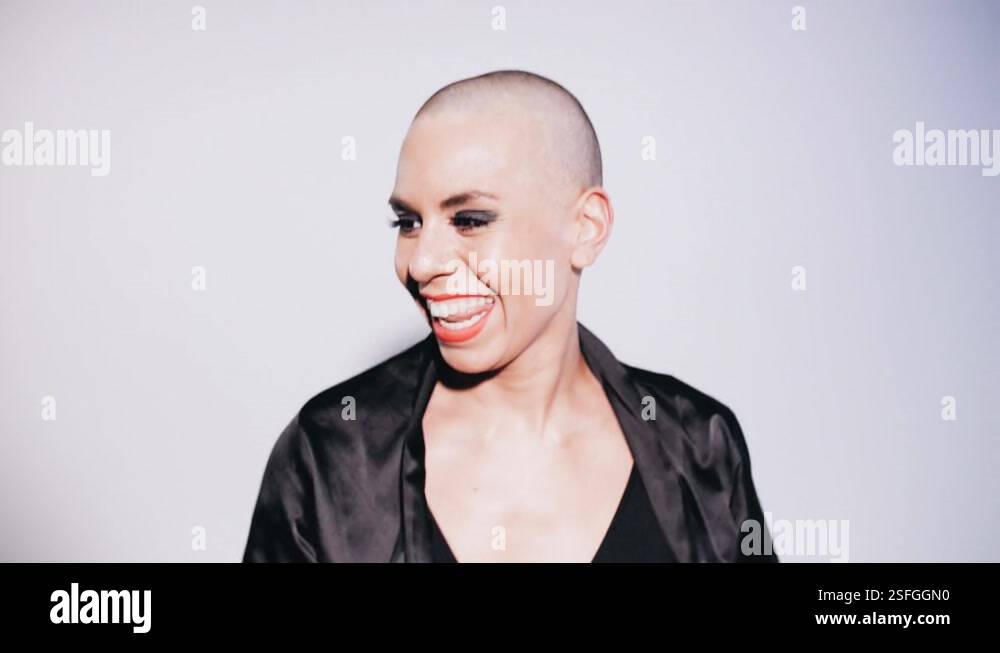 Happy bald headed tomboy female jumping and dancing. Happiness. Studio ...