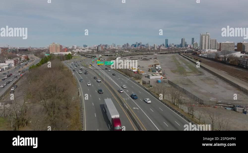 Fly above busy multilane trunk road. Highway leading in suburbs, high ...