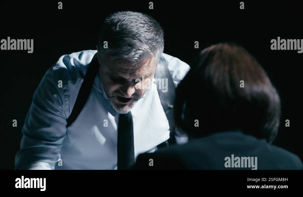 Angry investigator yelling at scared witness, showing evidence bag ...