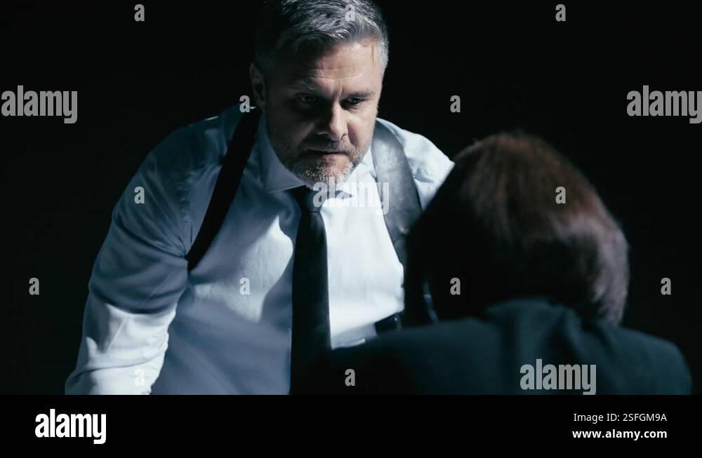 Aggressive police detective intimidating suspect, showing drugs in ...