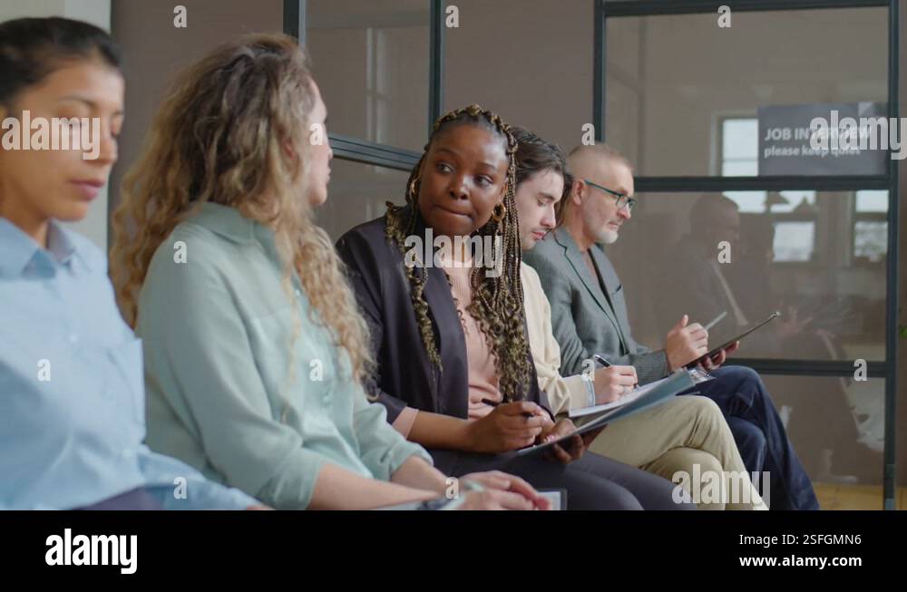 Women Sitting in Line and Chatting before Job Interview Stock Video ...