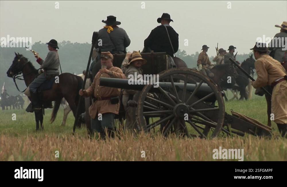 Civil War Union and Confederate re-enactor soldiers stand with a cannon ...