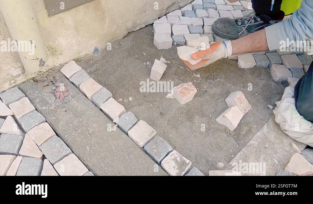 A paver breaking stone and building sidewalks. A masters of an art that ...