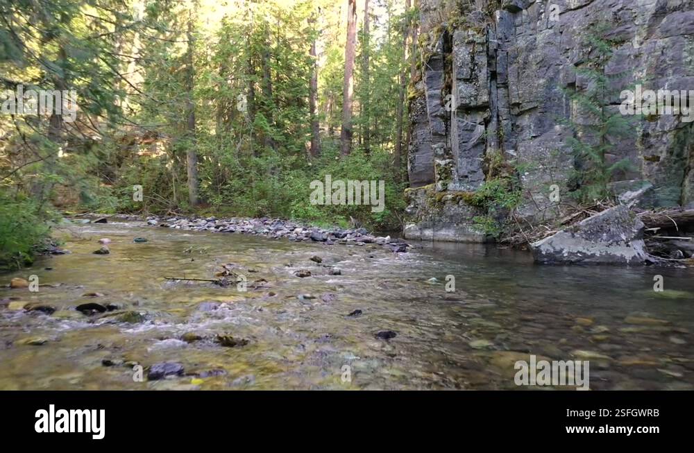 Shallow Water Flowing Through Rocky River With Rocky Cliffs In The ...