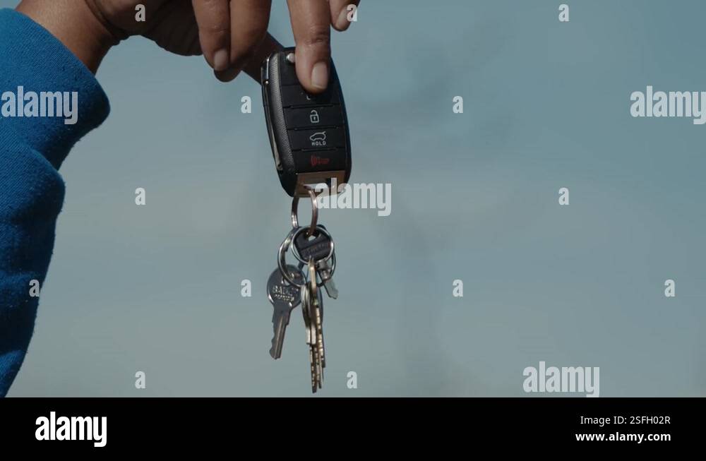 A set of keys being held up by a car key fob Stock Video Footage - Alamy