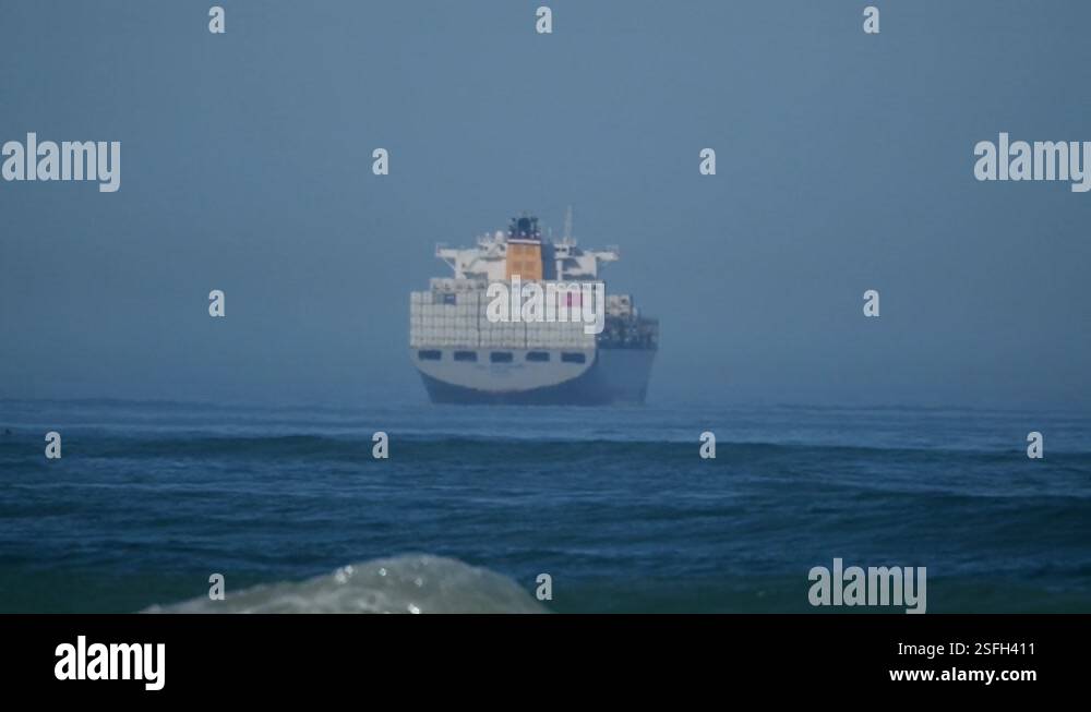 Container Ship on the horizon Stock Video Footage - Alamy