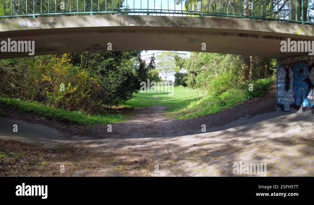 Along a path under a footbridge through into a park. Unbelievable ...