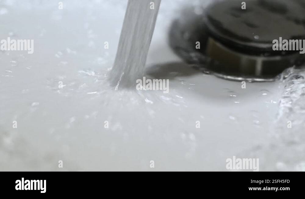 Strong jet of water from the faucet spills in the washbasin Stock Video ...