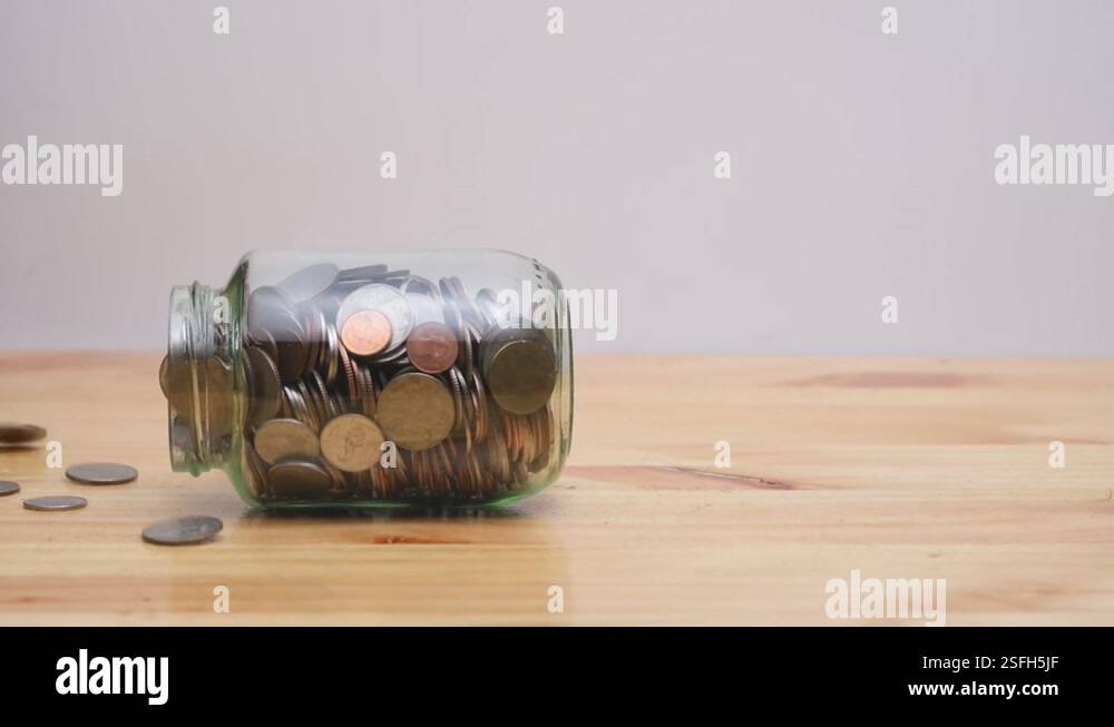 In slow motion, the coin slipped from the falling glass jar on the ...