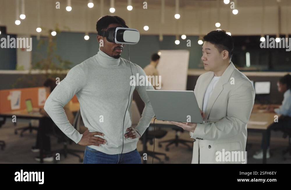 African american businessman testing a VR simulator headset while his ...