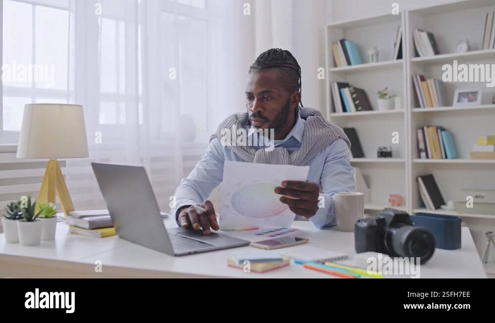 Man graphic designer looking at color chart, developing design for ...