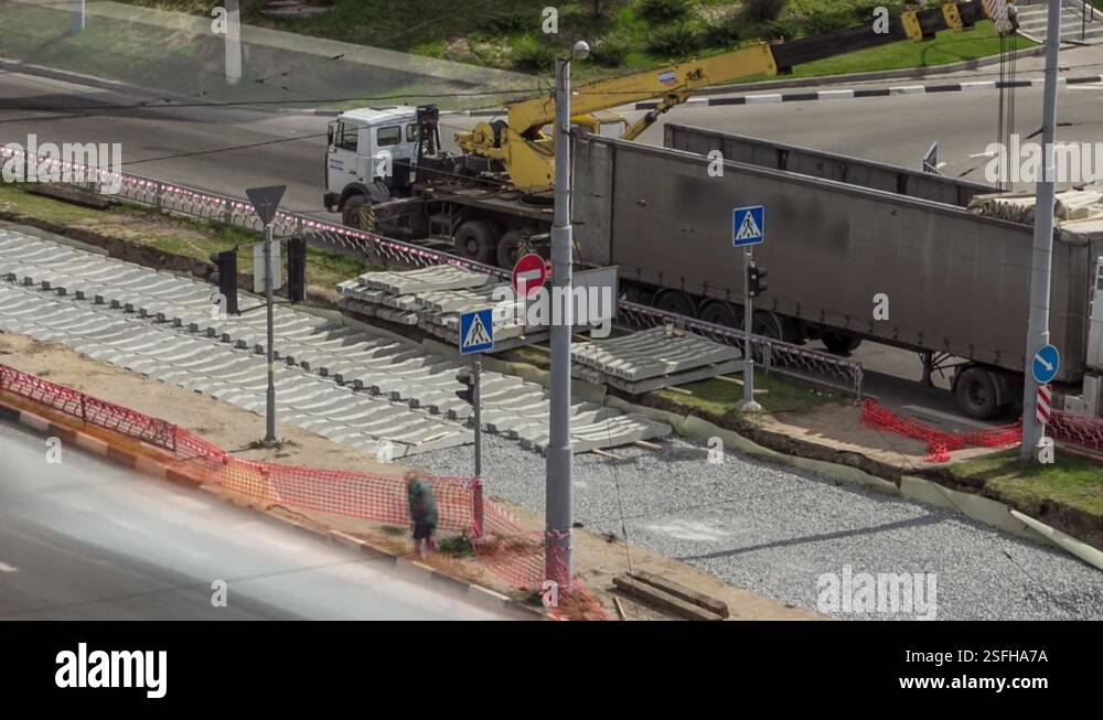 Loader crane for loading and unloading sleepers from truck which stands ...