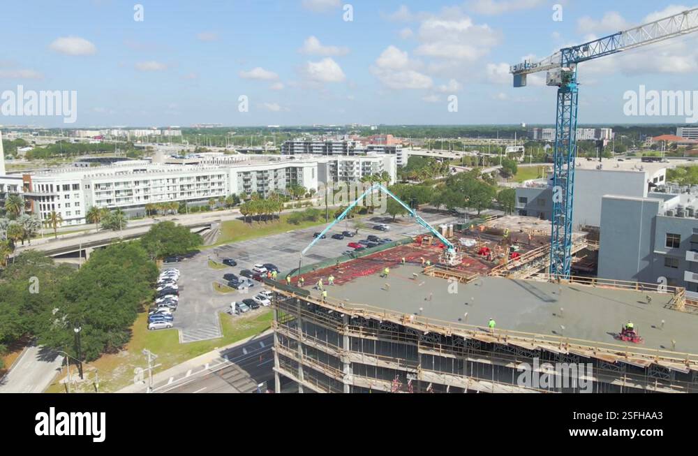 Crew of concrete workers pouring cement on a downtown building Stock ...