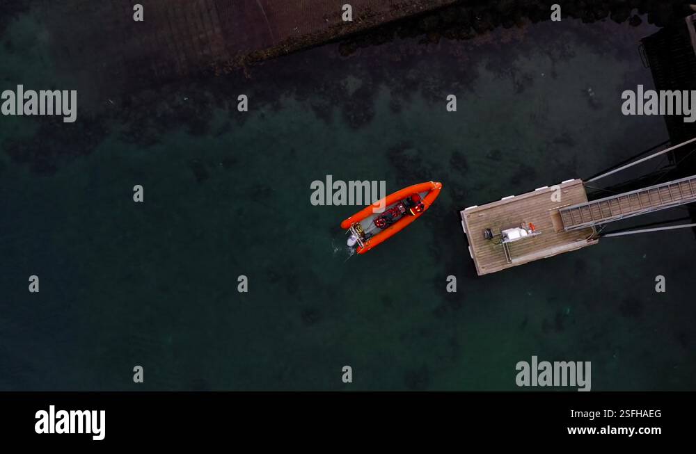 People On An Orange Speedboat Docking In The Portside Of Reykjavik ...