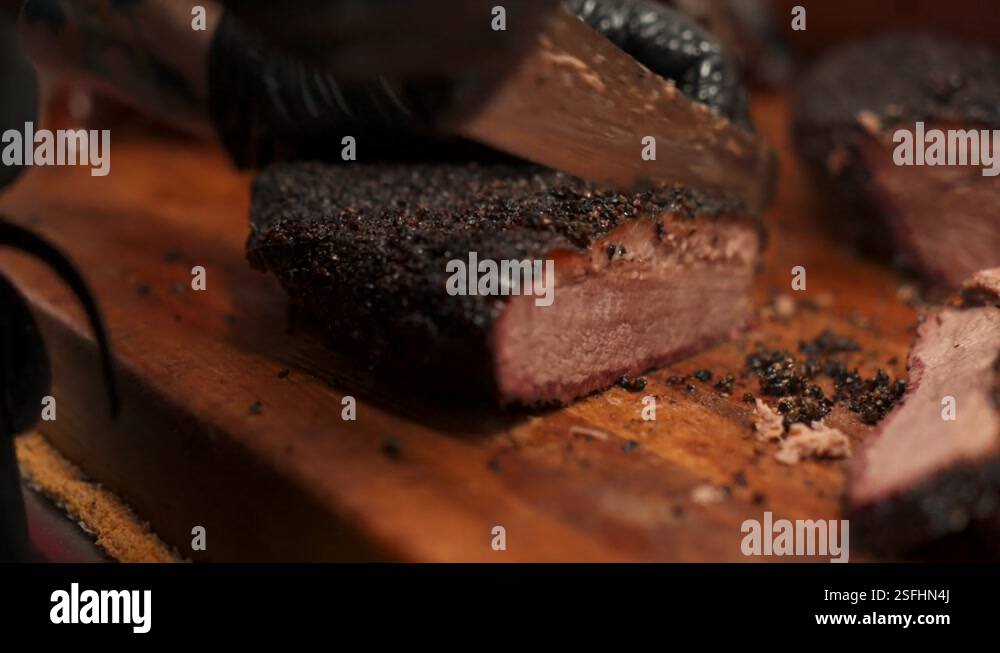 Chef slices tender moist lean Texas beef brisket with precision ...