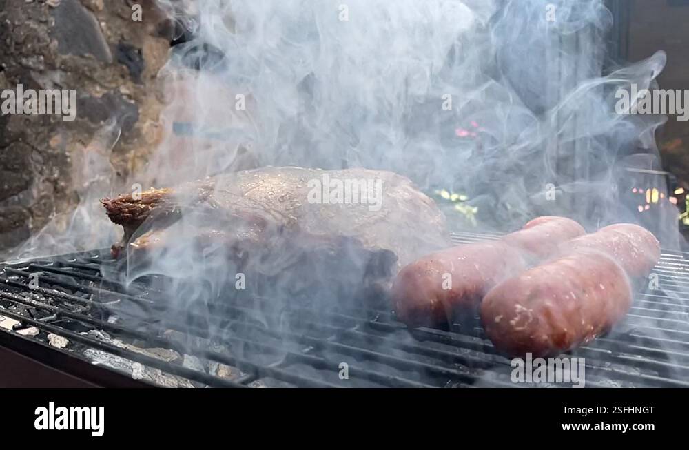 slow motion scene of Argentinian meat and sausages on the grill Stock ...