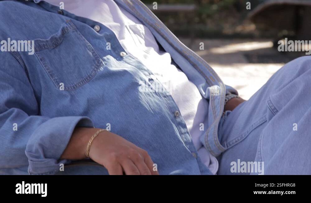 Pan down of older man rocking in chair on outdoor patio Stock Video ...