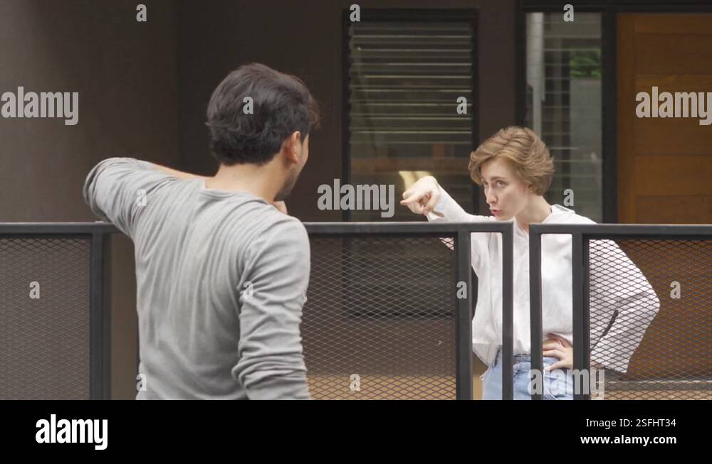 An angry neighbor shouting, blaming, yelling at each other in their ...