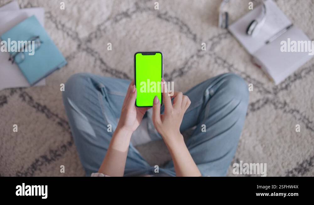 Woman scrolling, swiping and zooming on green screen smartphone, top view Stock Video Footage ...