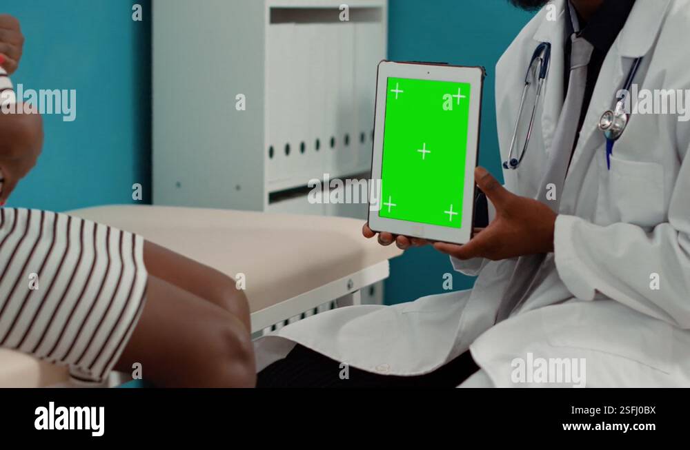 General practitioner holding digital tablet with greenscreen Stock ...