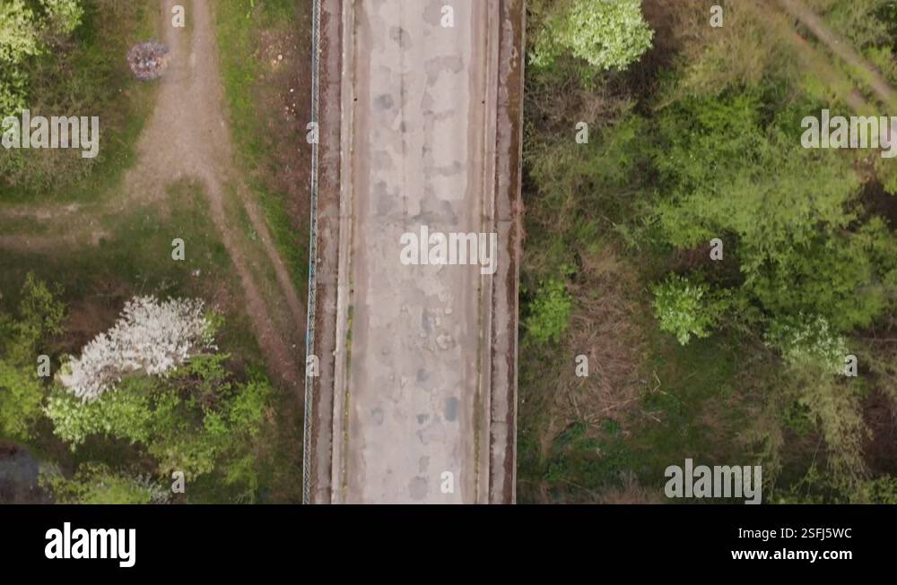 Two black sedan cars drive by at the old bridge in Stock Video Footage ...